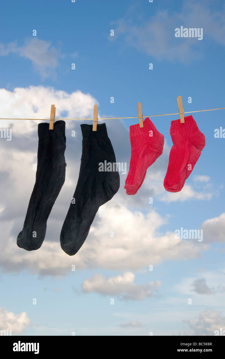 Socks hanging on clothesline Stock Photo - Alamy