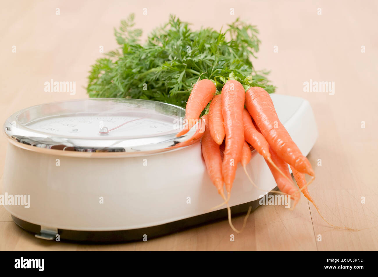 Carrots on bathroom scales Stock Photo - Alamy