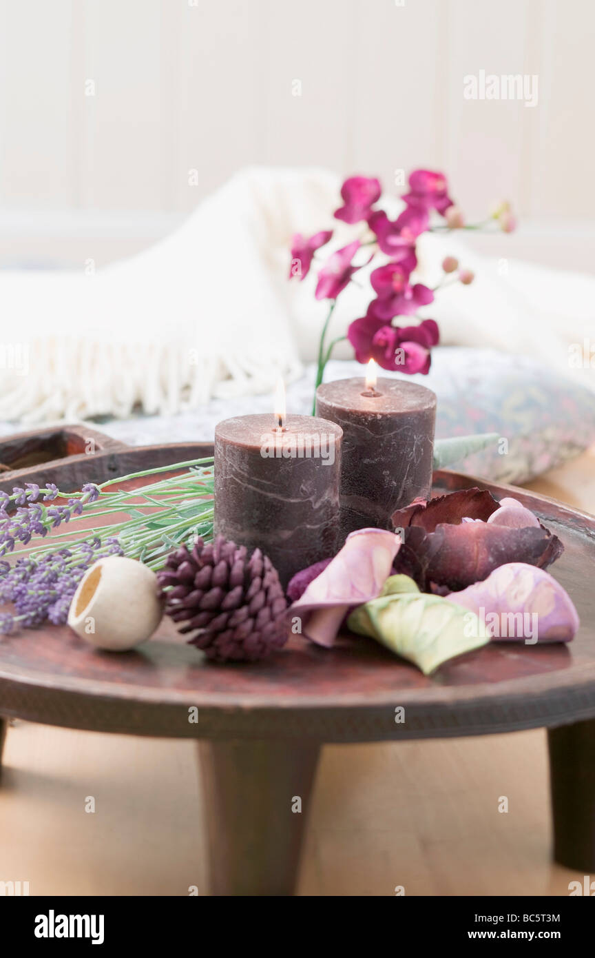 A small table with decorative objects and burning candles Stock Photo ...