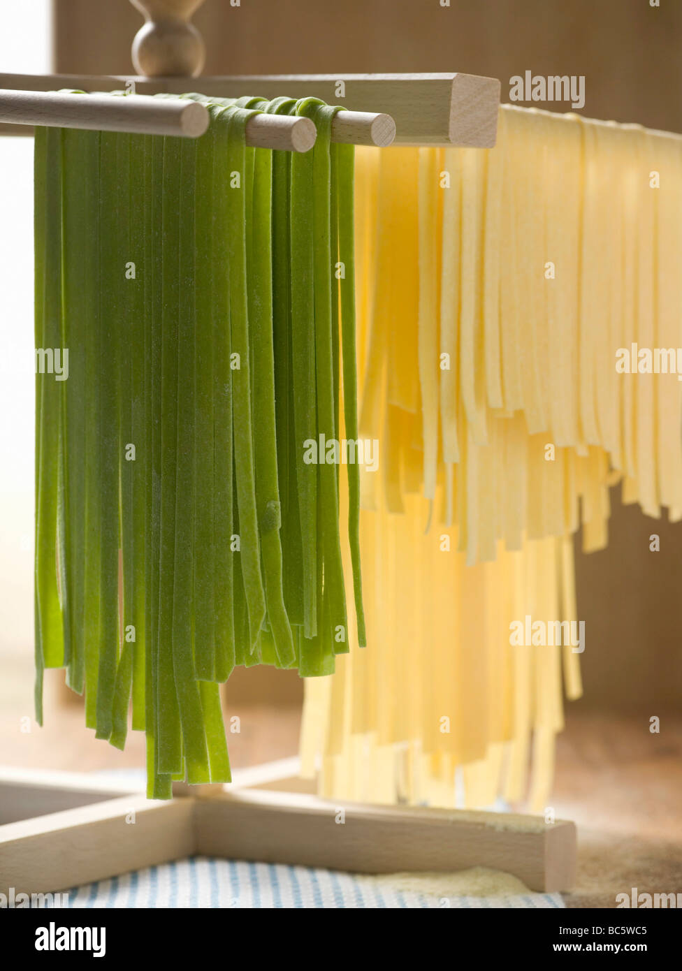 Home-made ribbon pasta hanging up to dry Stock Photo - Alamy