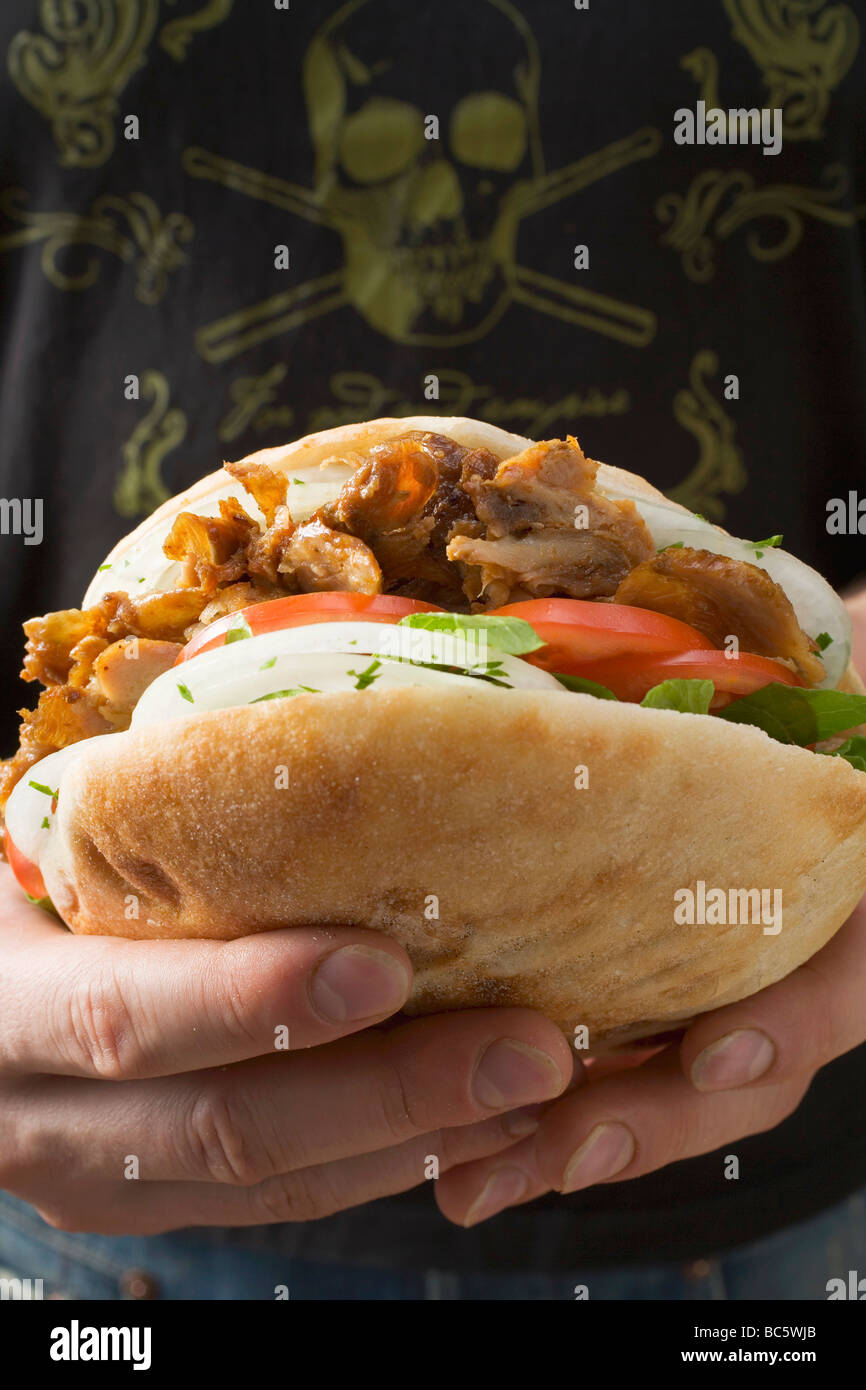 Person holding döner kebab Stock Photo - Alamy