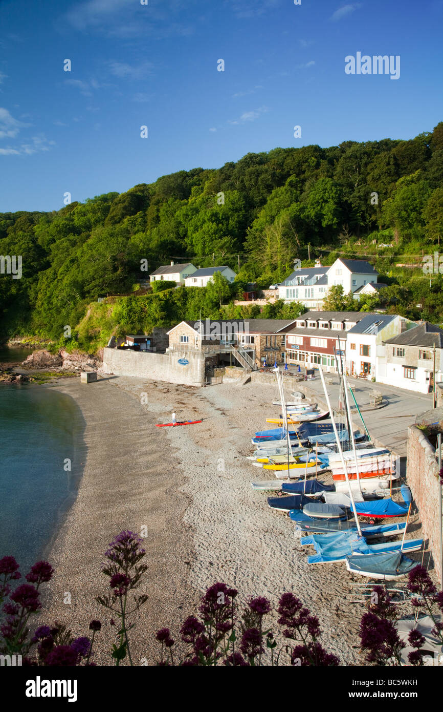 Cawsand seafront on a hot summers day with blue sky and colourful boats ...