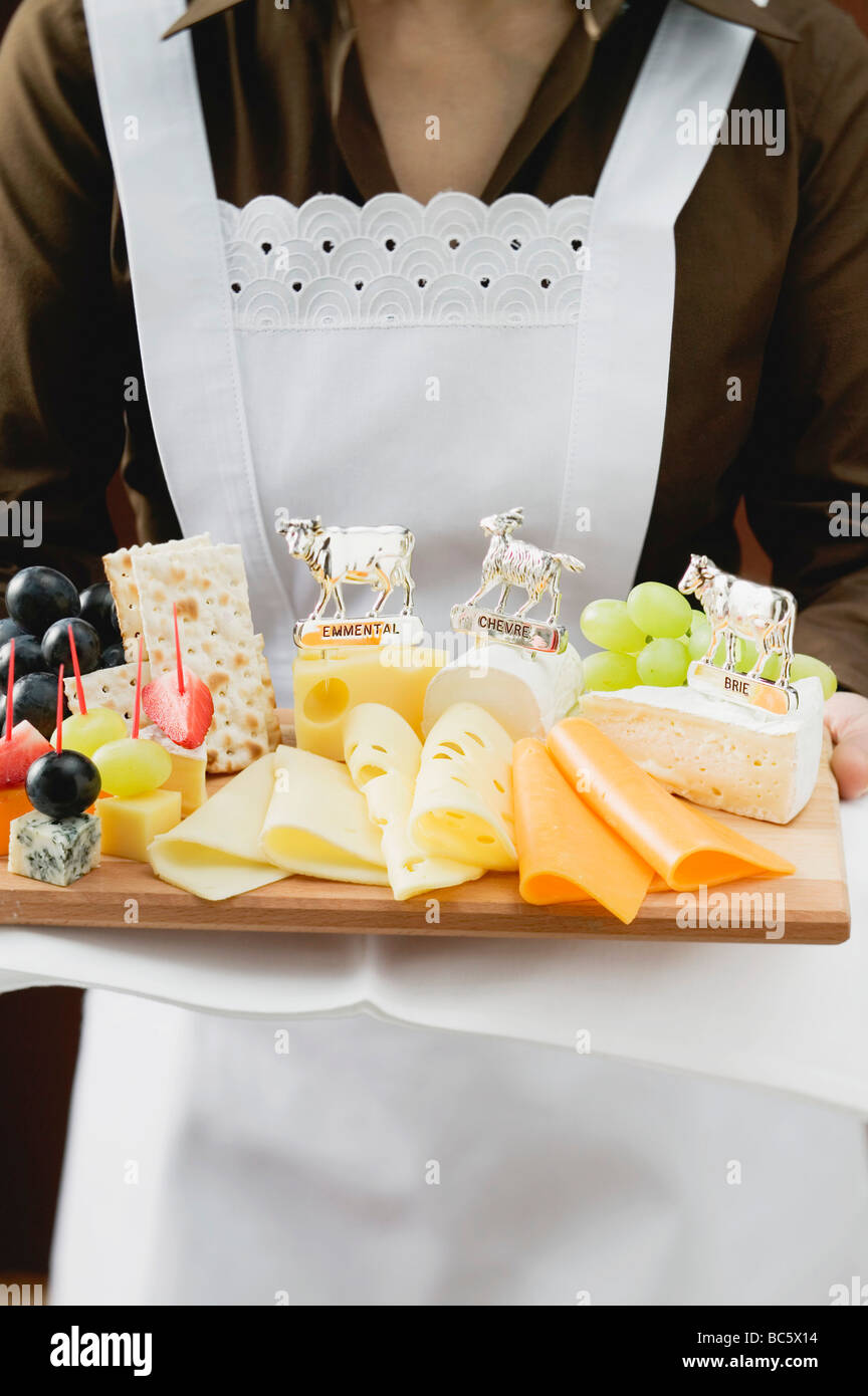 Waitress serving a cheese platter Stock Photo - Alamy