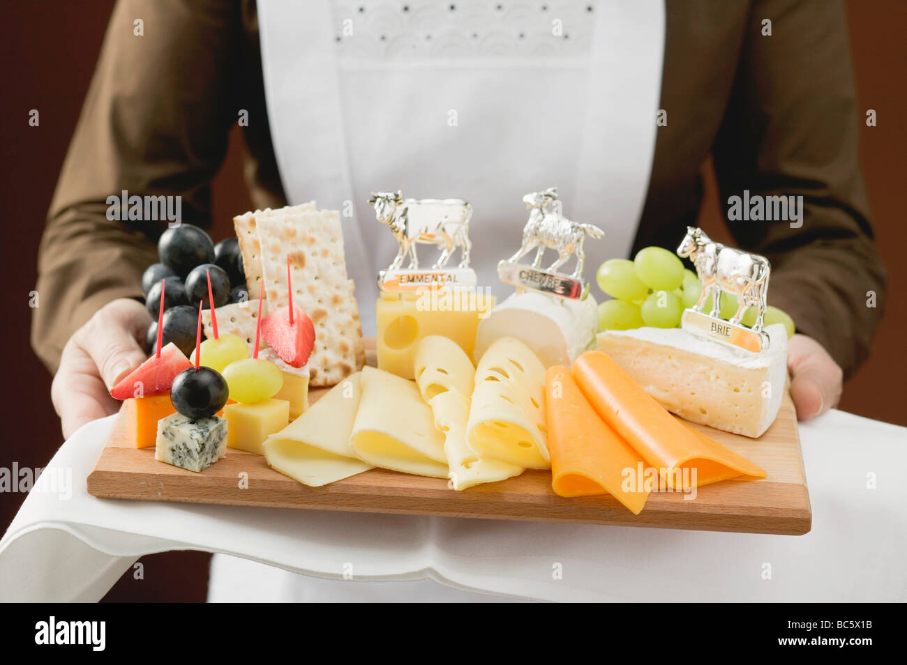 Waitress serving a cheese platter Stock Photo - Alamy