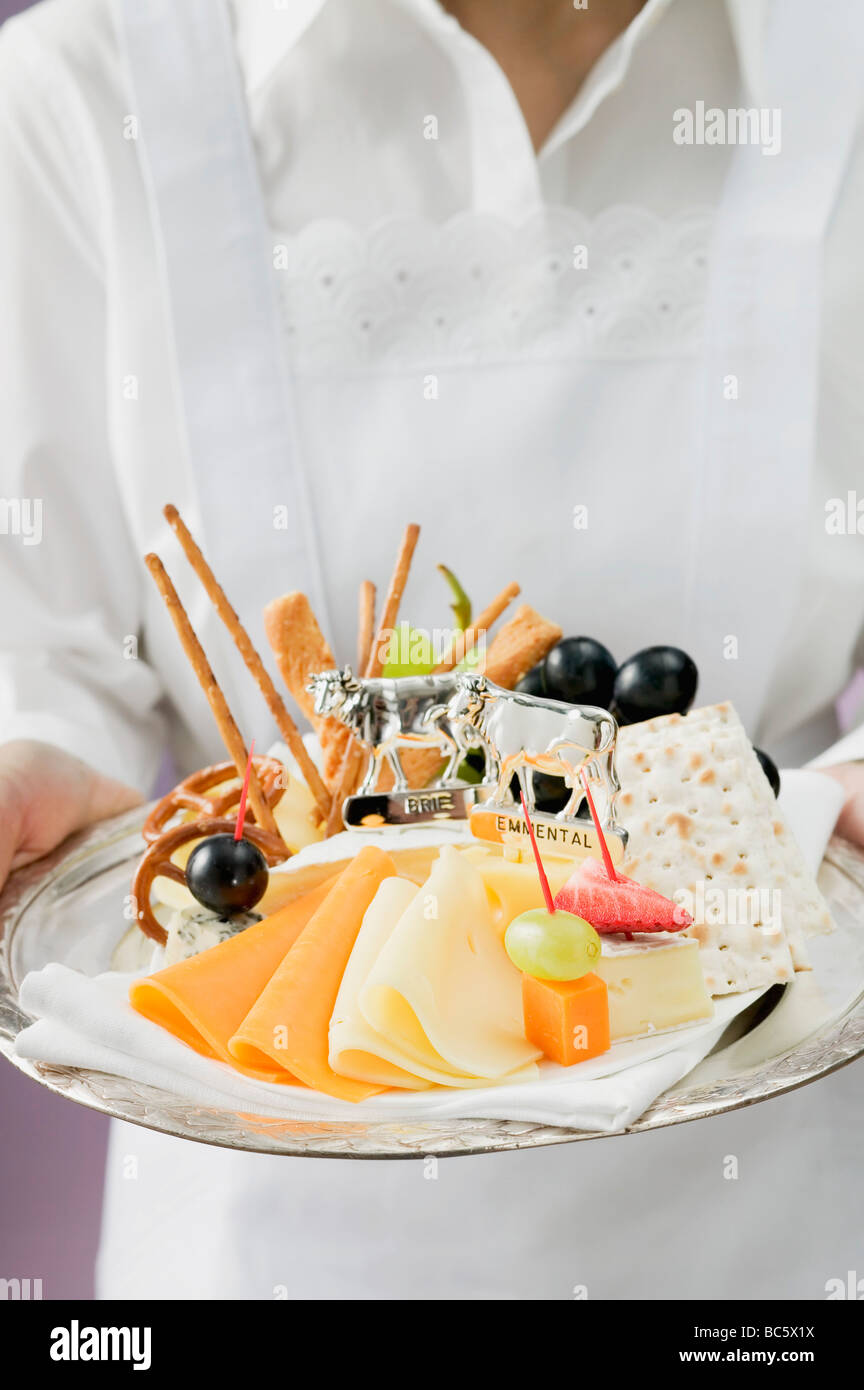 Waitress serving a cheese platter Stock Photo - Alamy