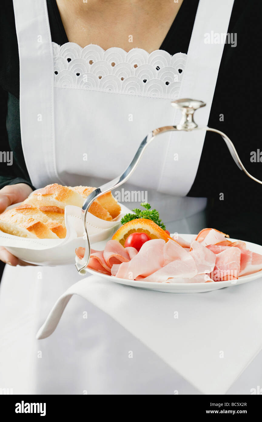 Waitress serving ham and white bread Stock Photo - Alamy