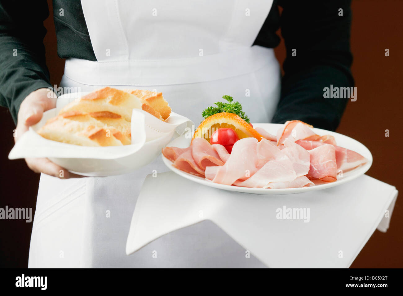 Waitress serving ham and white bread Stock Photo - Alamy