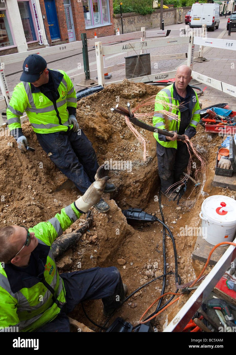 EDF workers repairing an electrical cable in the ground Stock Photo - Alamy