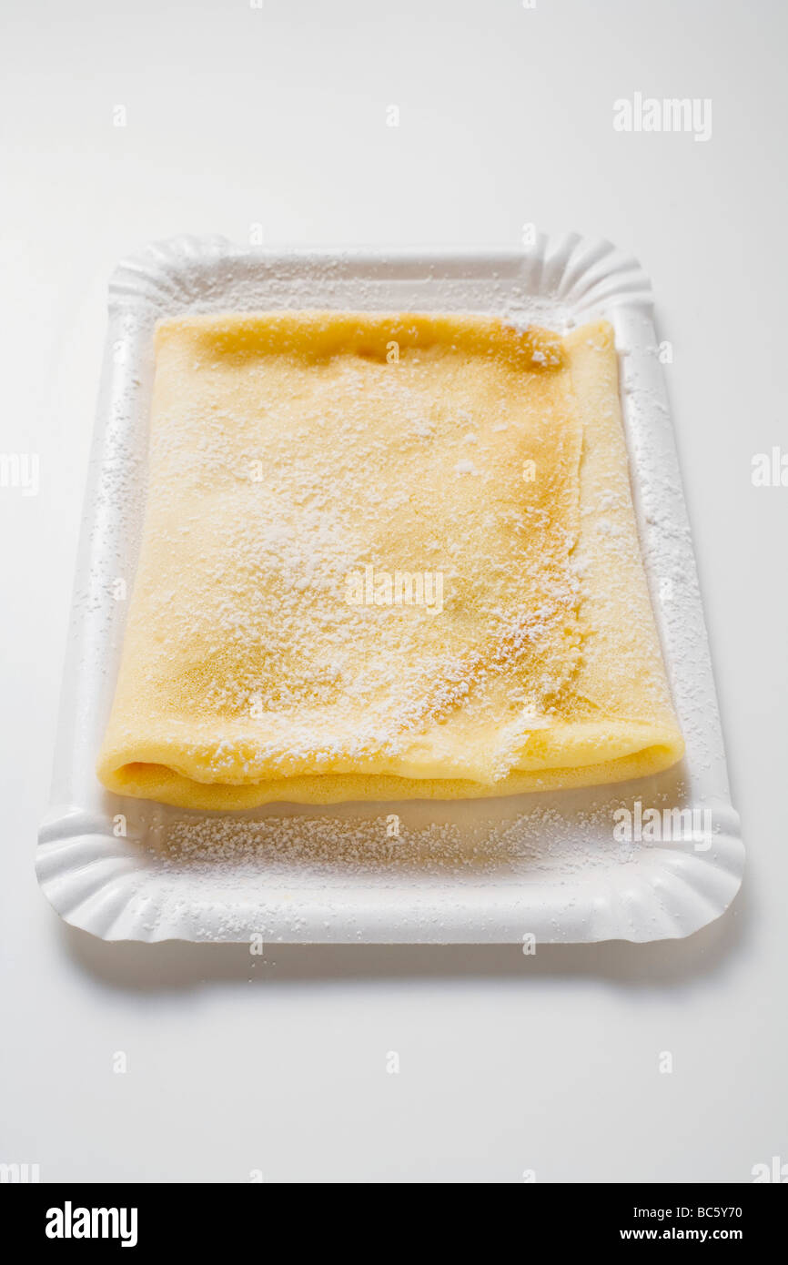 Crêpe with icing sugar on paper plate Stock Photo - Alamy