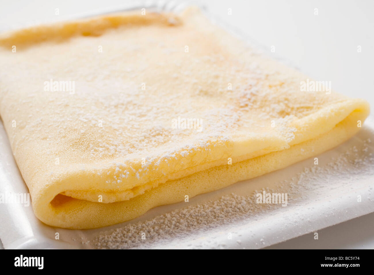 Crêpe with icing sugar on paper plate (close-up Stock Photo - Alamy