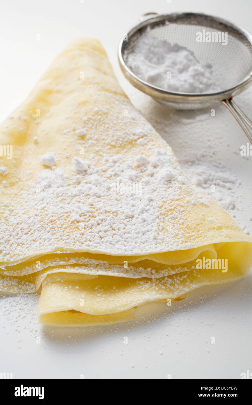 Folded crêpe with icing sugar Stock Photo - Alamy