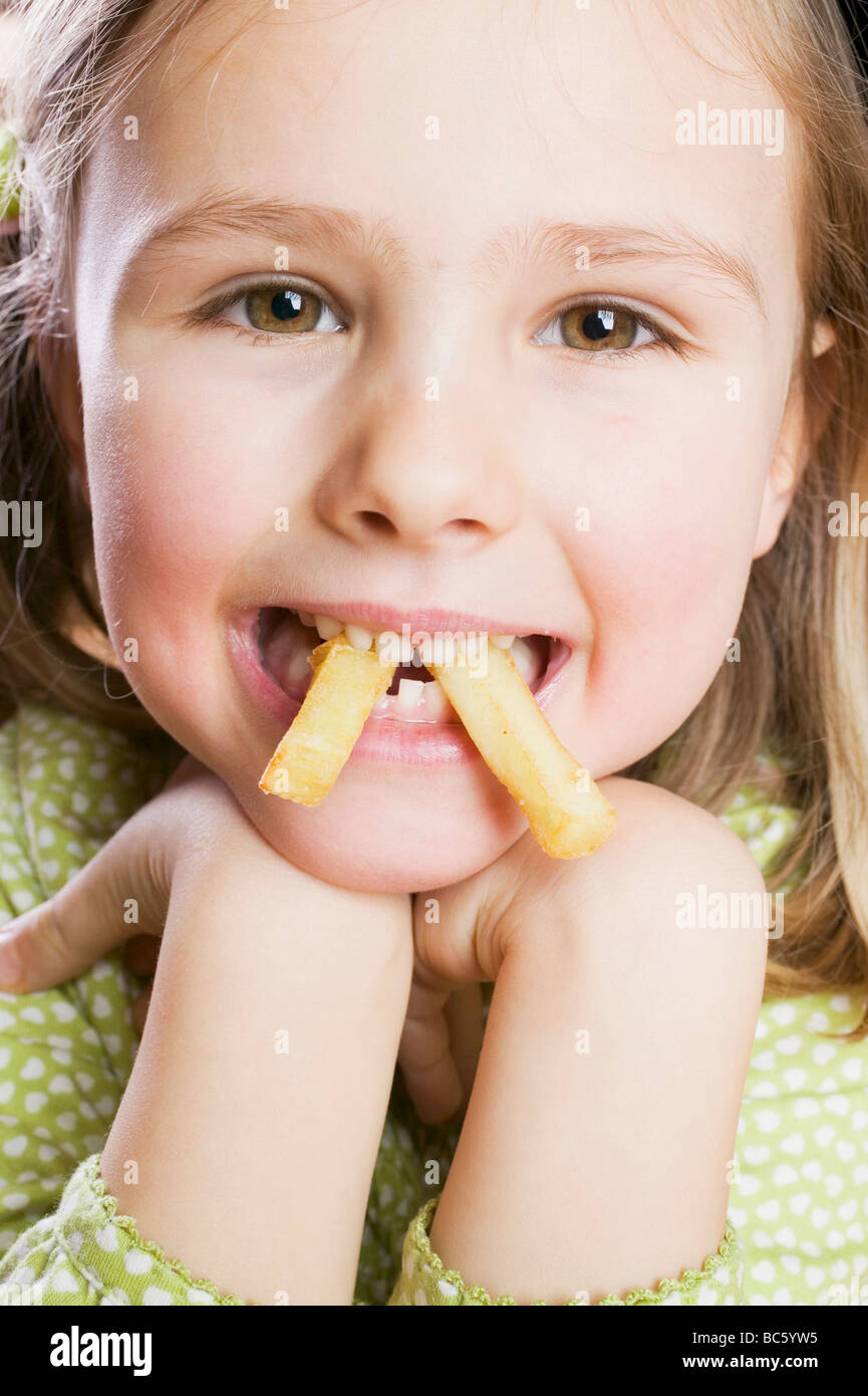 Girl eating chips Stock Photo - Alamy