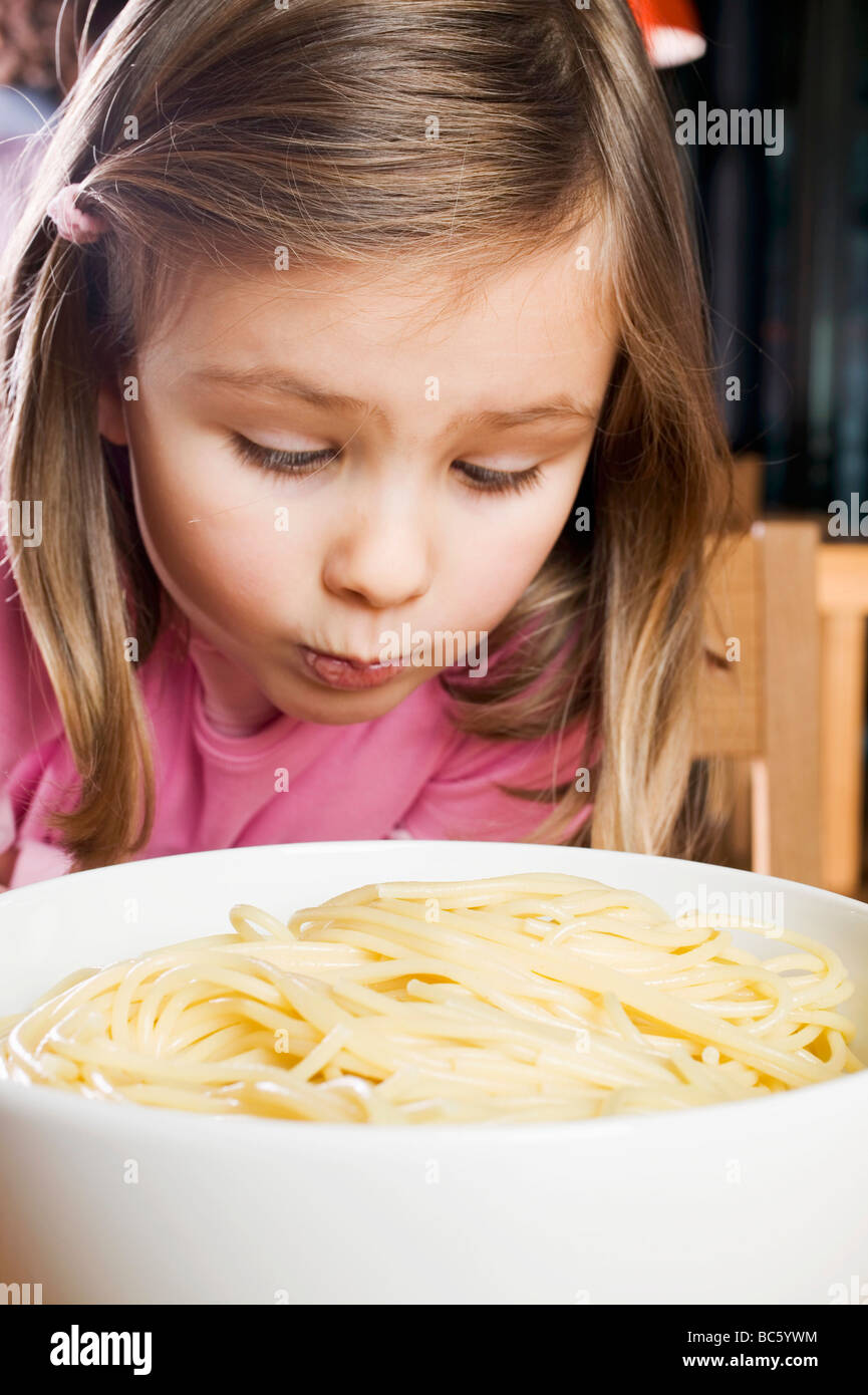 Girl looking sadly at cooked spaghetti Stock Photo - Alamy