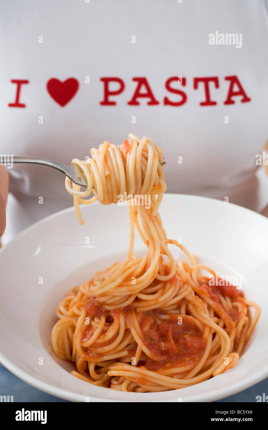Woman eating spaghetti with tomato sauce Stock Photo - Alamy