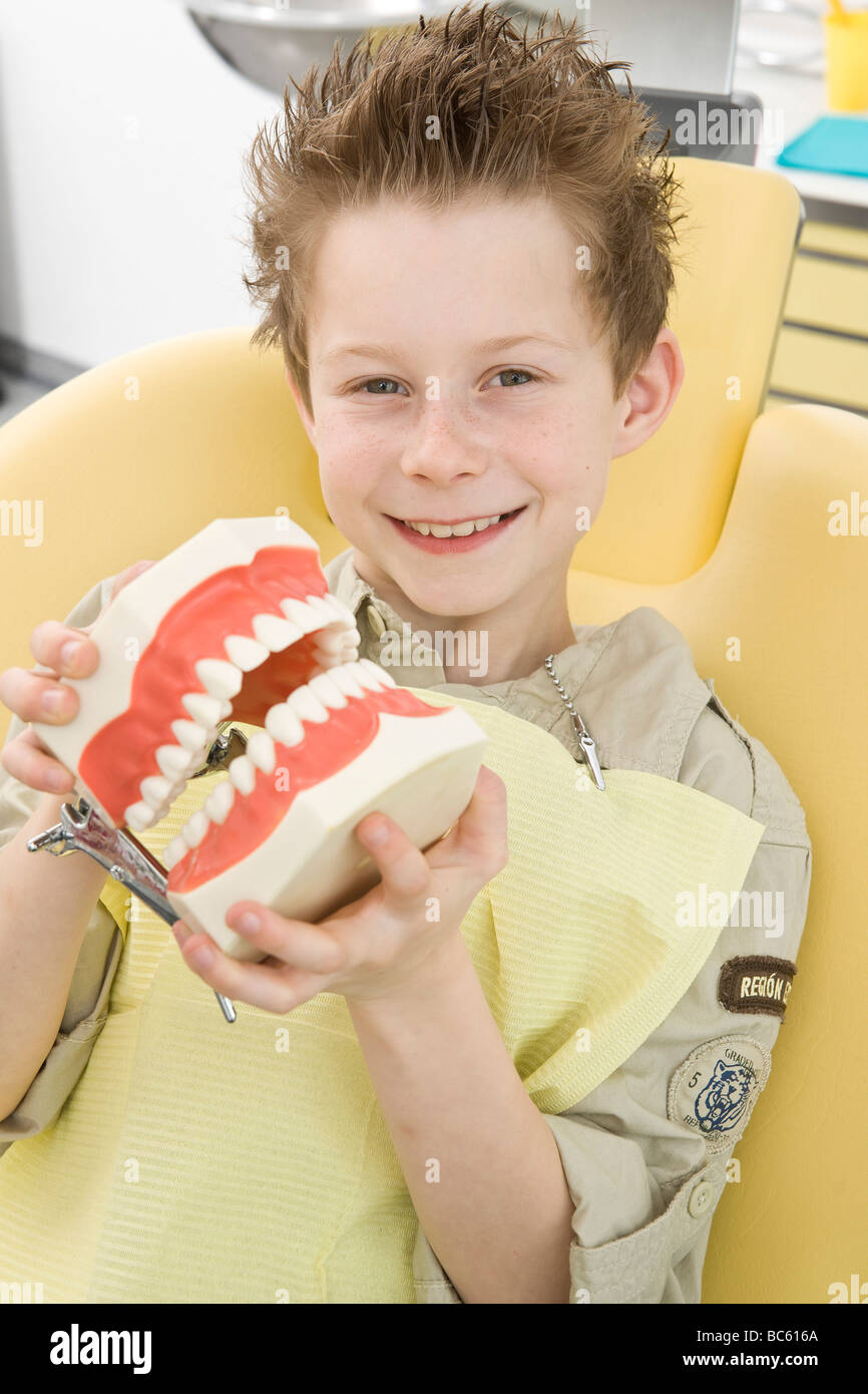 Portrait of boy holding denture Stock Photo - Alamy