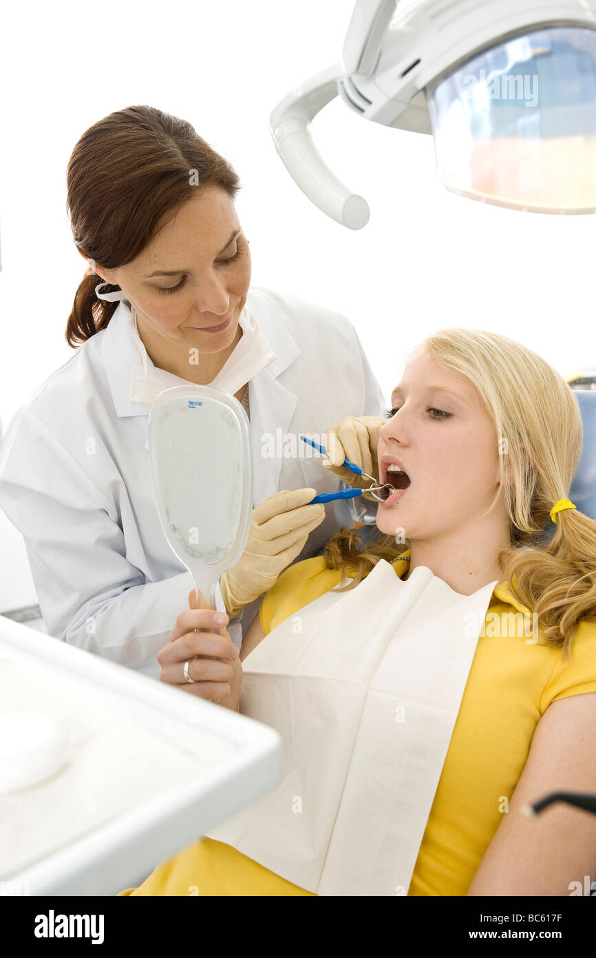 Female dentist examining patient's teeth Stock Photo - Alamy