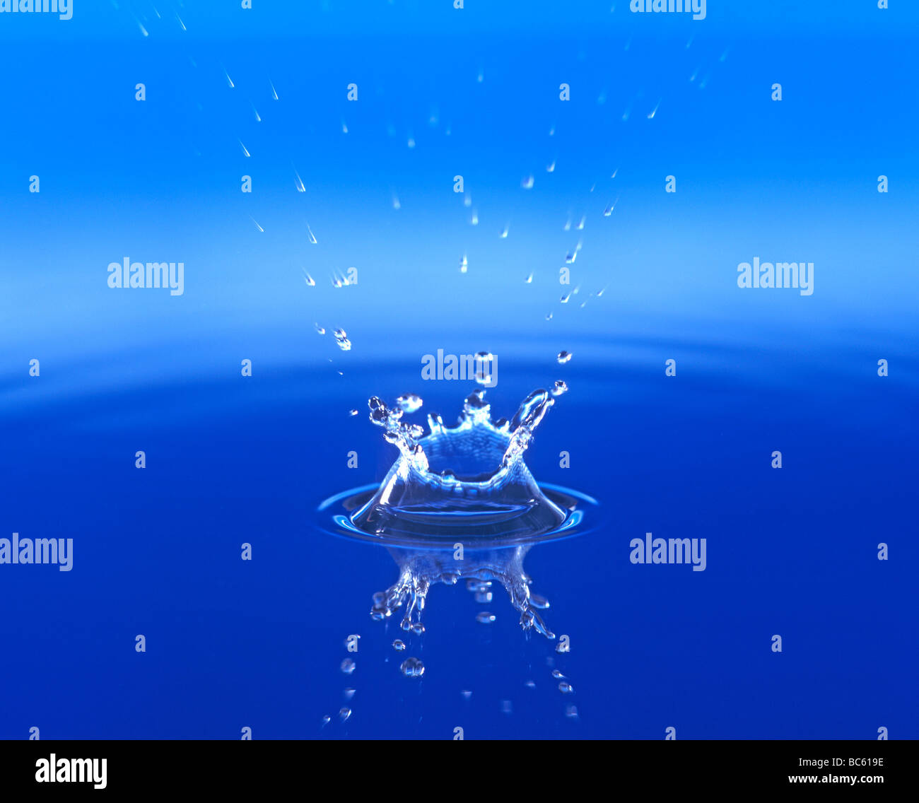 Water drop in blue water Stock Photo - Alamy