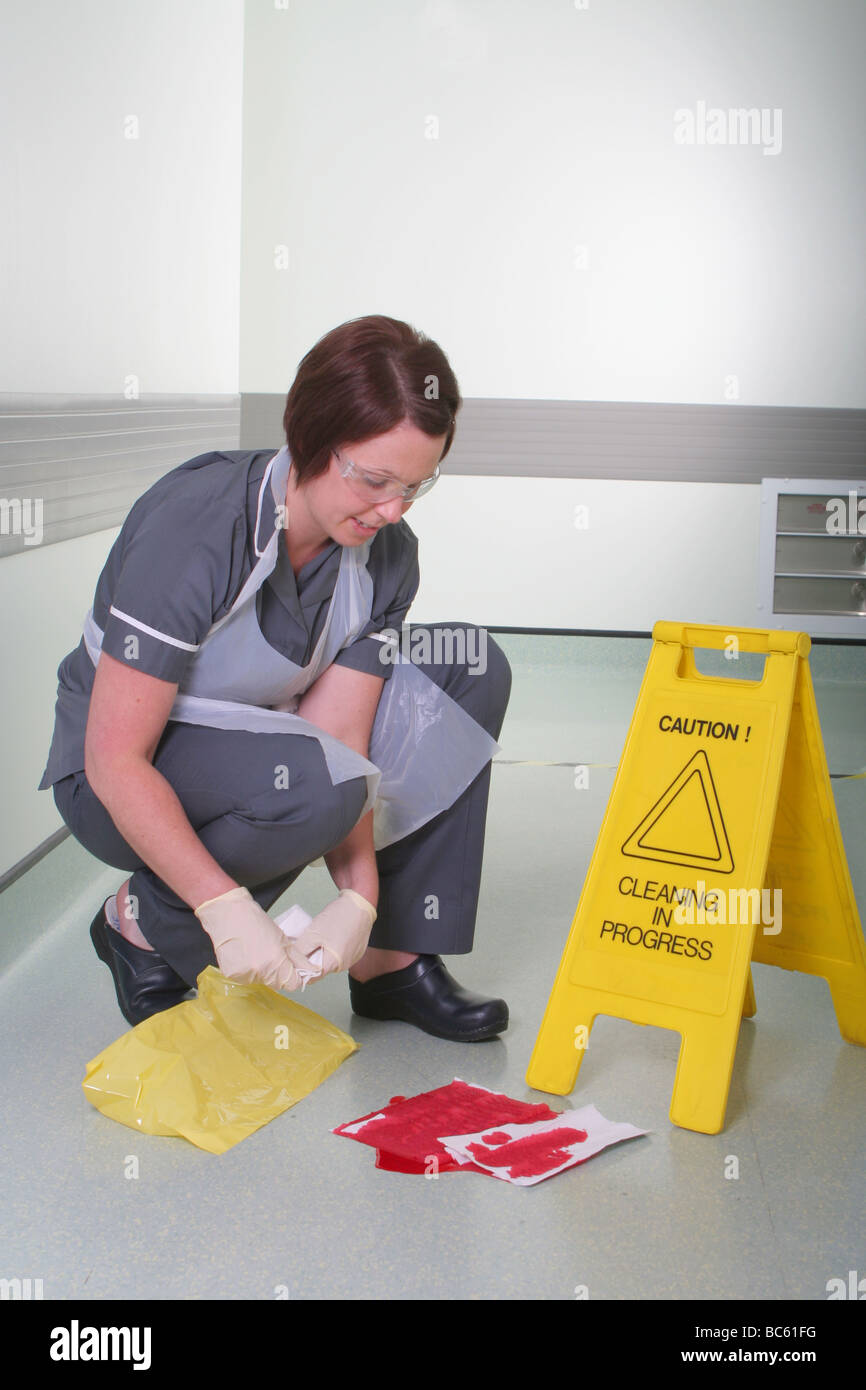 Nurse clearing blood from hospital corridor Stock Photo - Alamy