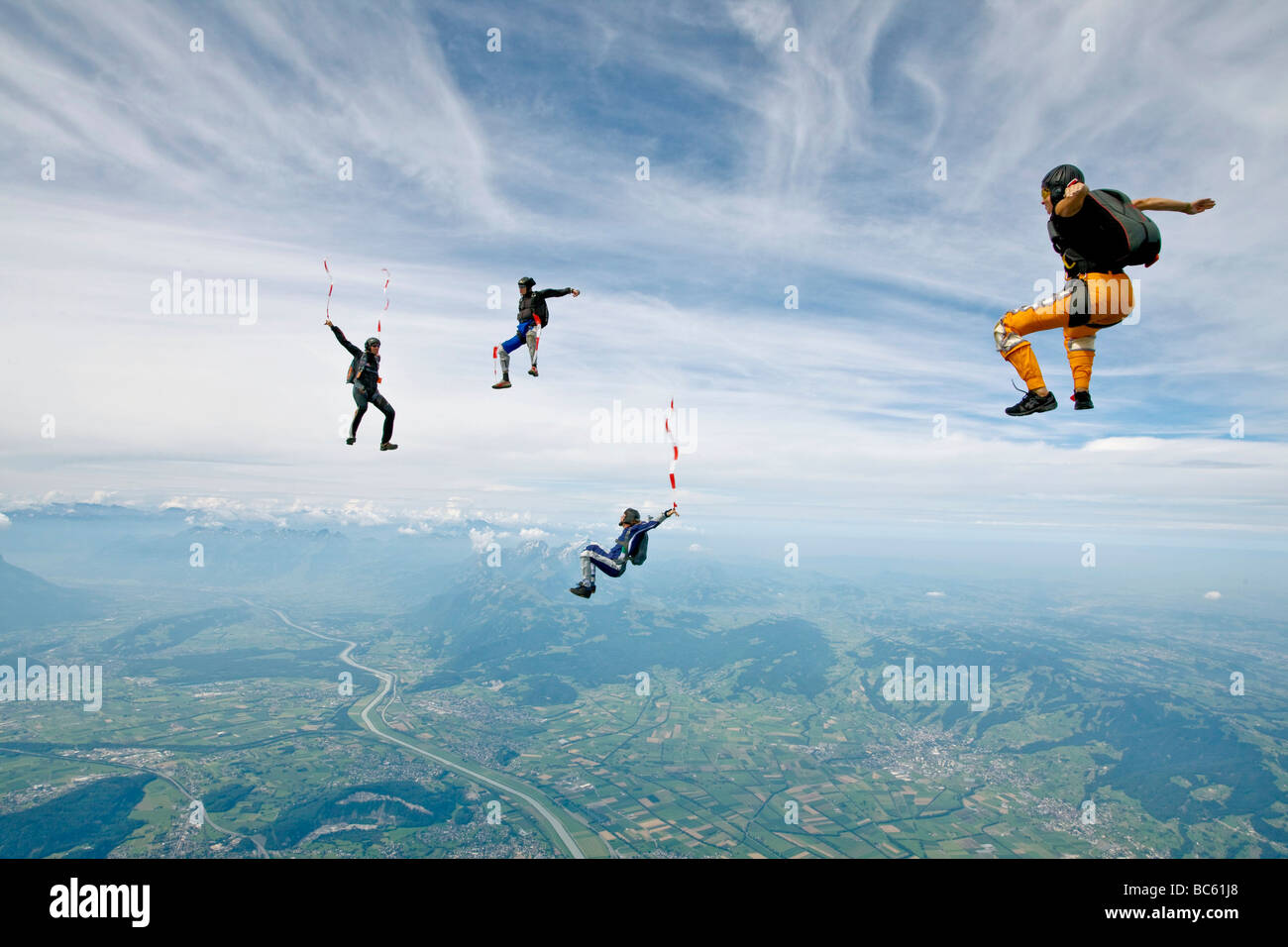 Four parachutists doing free fall, Switzerland Stock Photo - Alamy