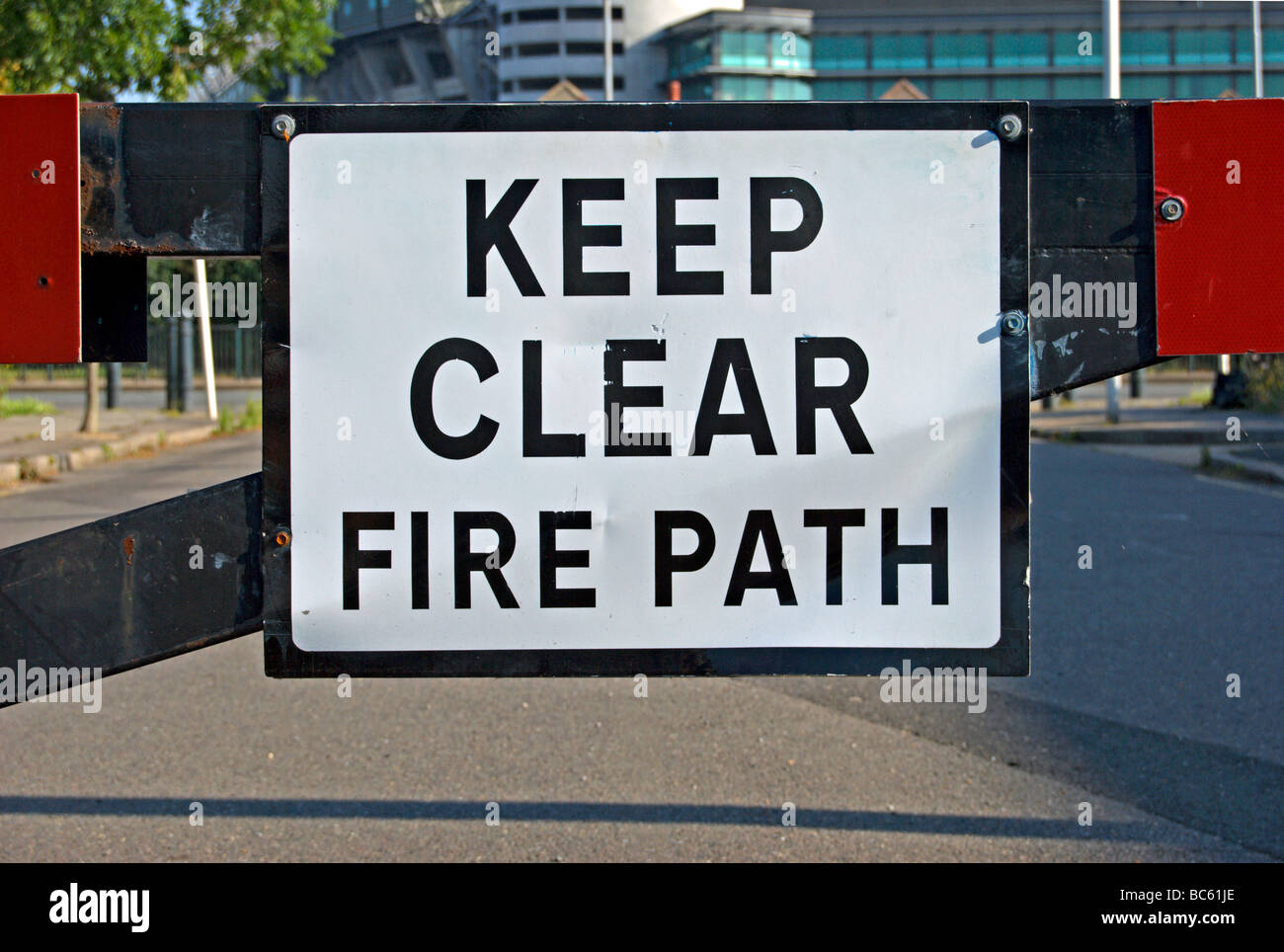 british keep clear fire path sign fixed to a barrier in a residential ...