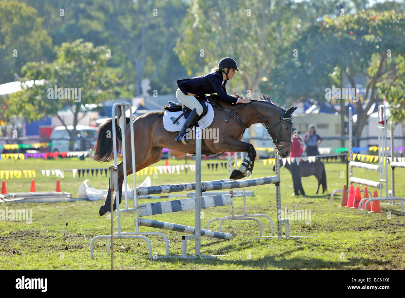 Horse jumping competition at local show with women riders Stock Photo ...
