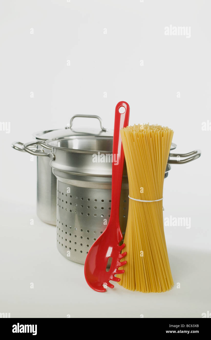 Spaghetti, pans and spaghetti server Stock Photo - Alamy