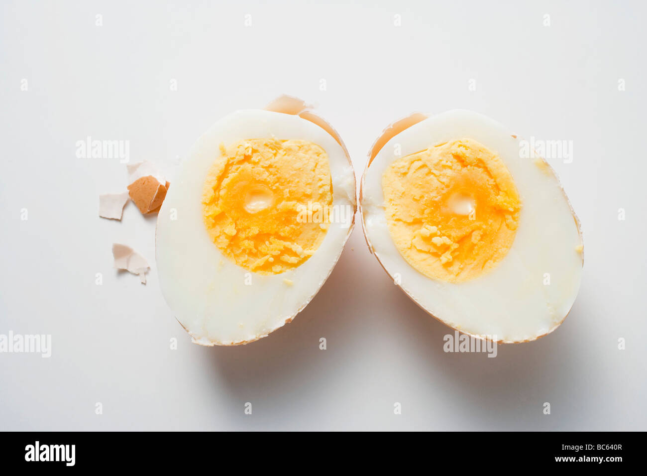 Hard-boiled egg with shell, halved Stock Photo - Alamy