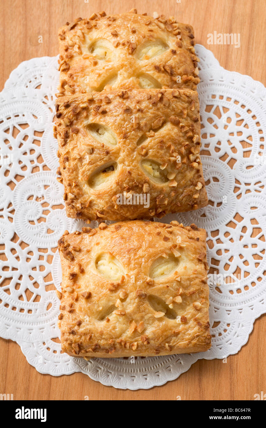 Three puff pastries on doily Stock Photo - Alamy