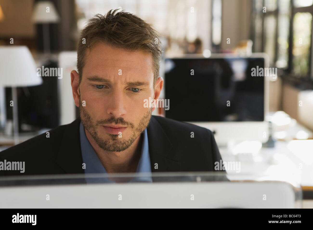 Business man in office using computer, portrait Stock Photo - Alamy