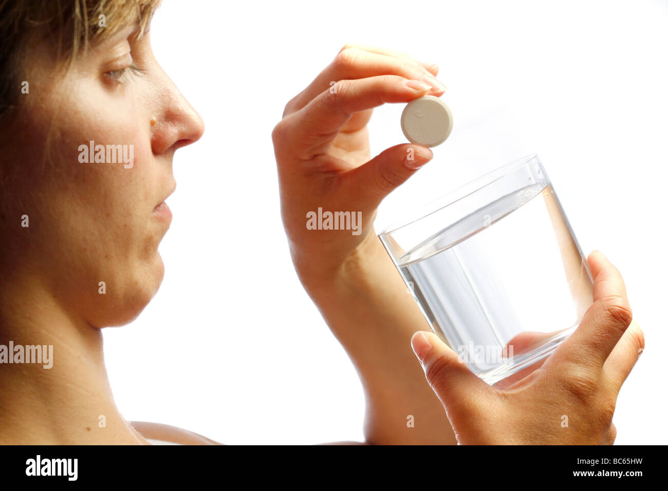 Woman is solving a fizzy tablet in water Pill capsule medicament Stock ...