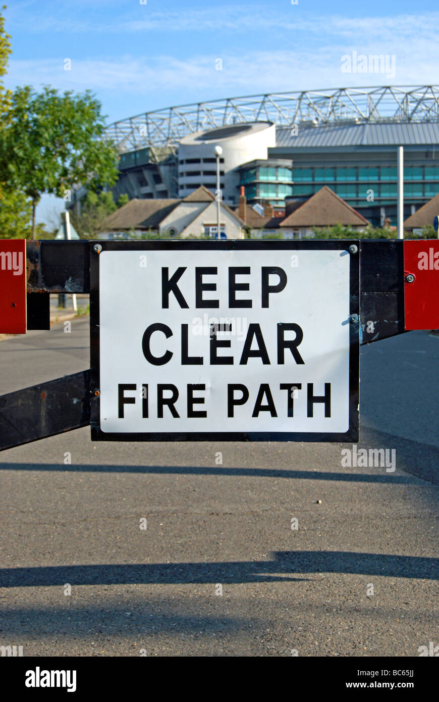 british keep clear fire path sign fixed to a barrier in a residential ...