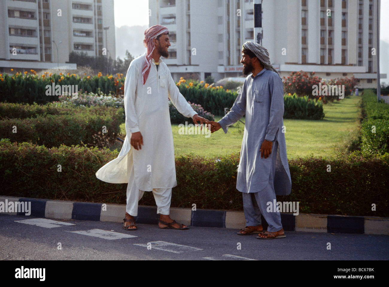 Arab men holding hands hi-res stock photography and images - Alamy