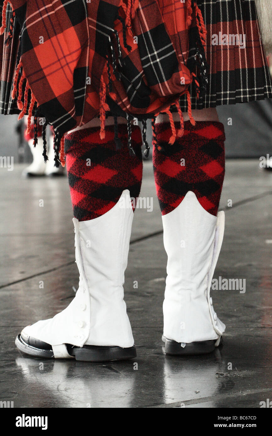 Piper in White Over Boots clad in the Ramsay tartan Stock Photo - Alamy