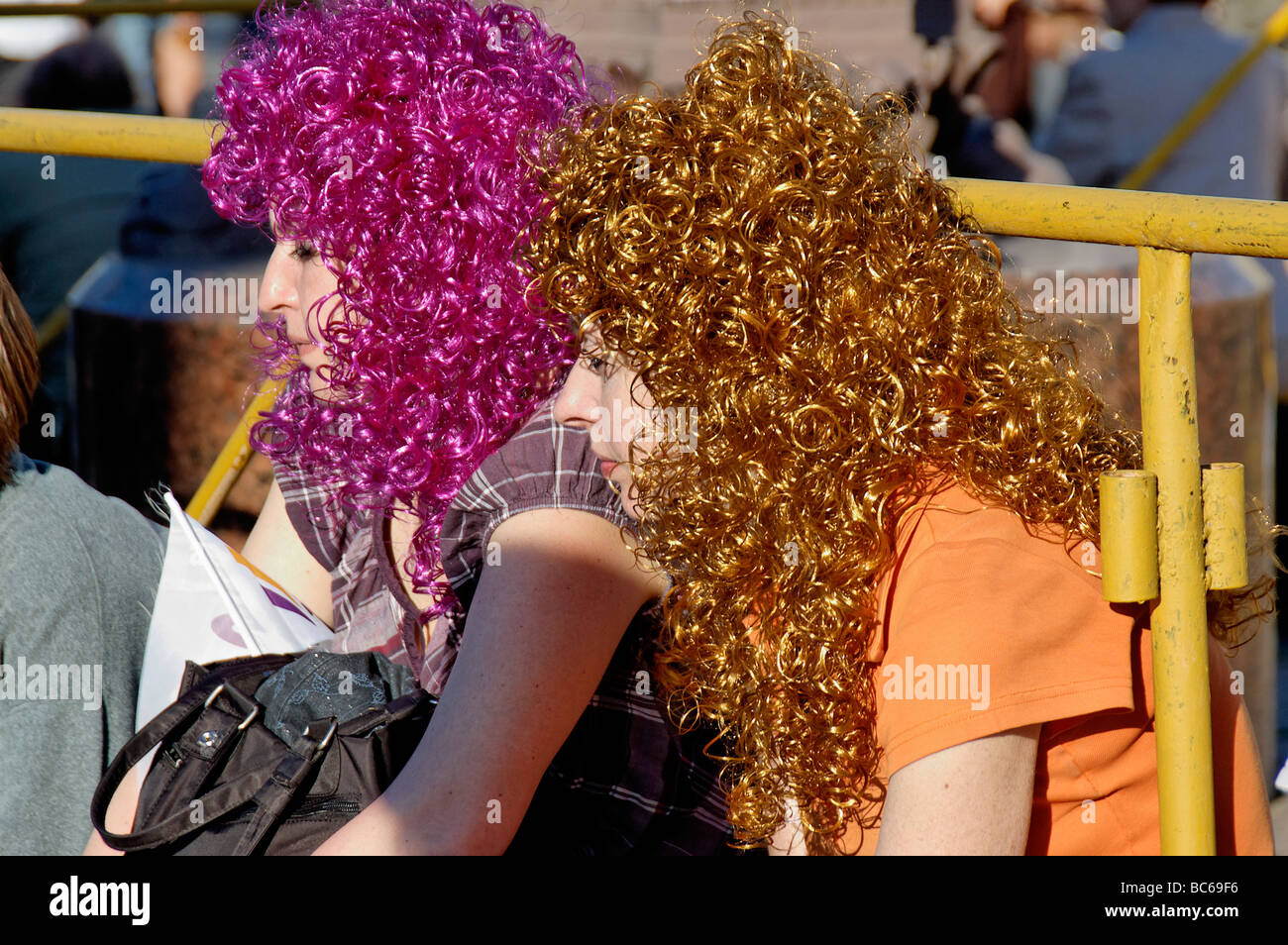 Two young women in the multi coloured wigs during city festival Stock ...