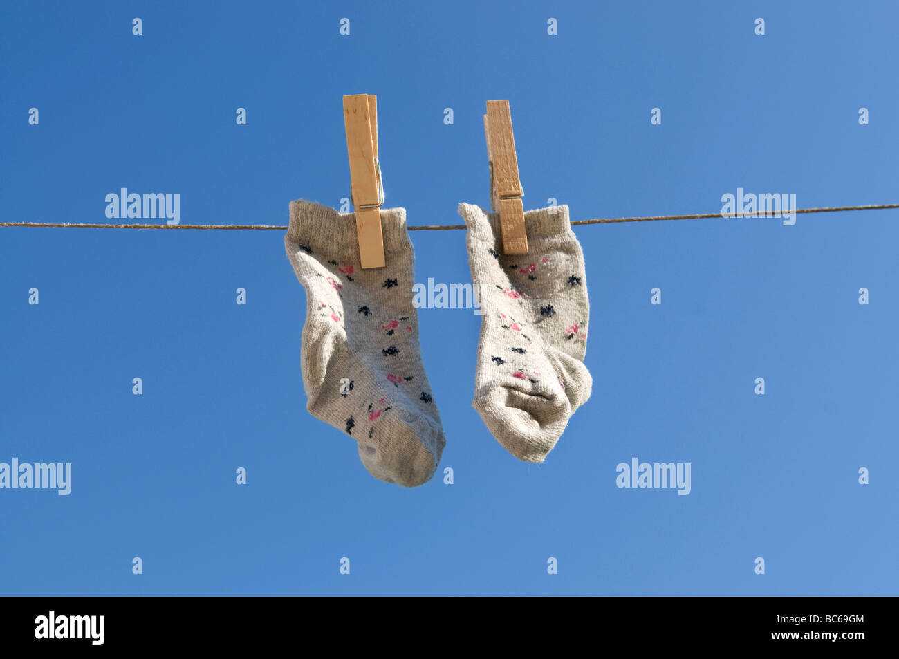 Baby socks hanging on a washing line Stock Photo - Alamy