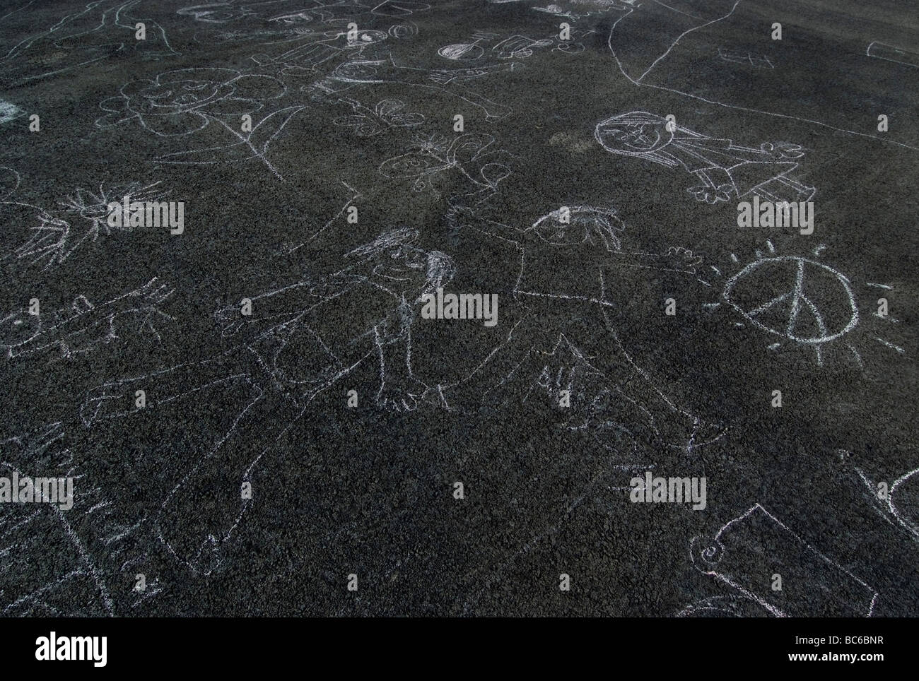 Chalk figures drawn on the pavment in school yard Playground in San ...