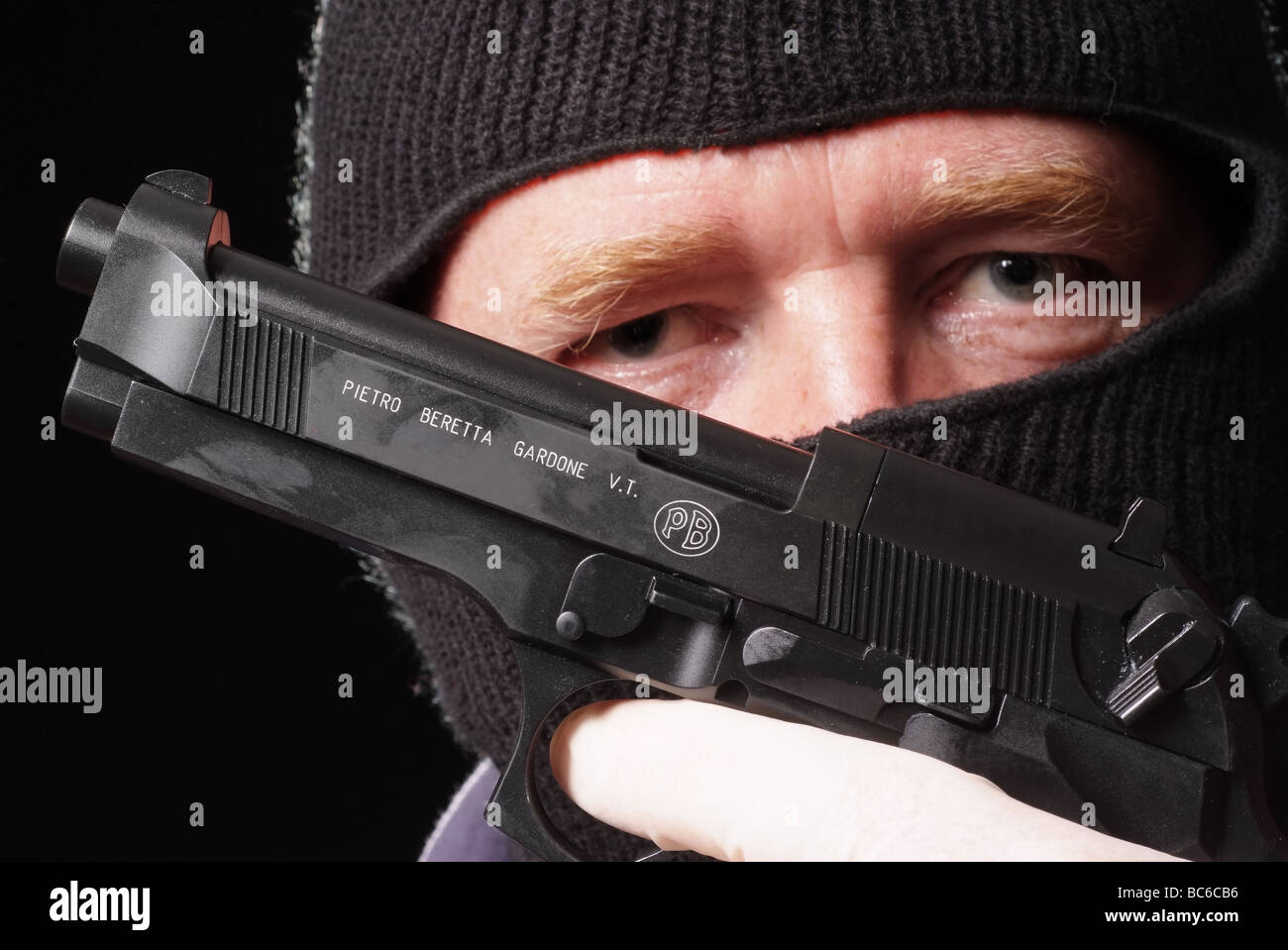 GUNMAN WITH HANDGUN WEARING BALACLAVA Stock Photo - Alamy