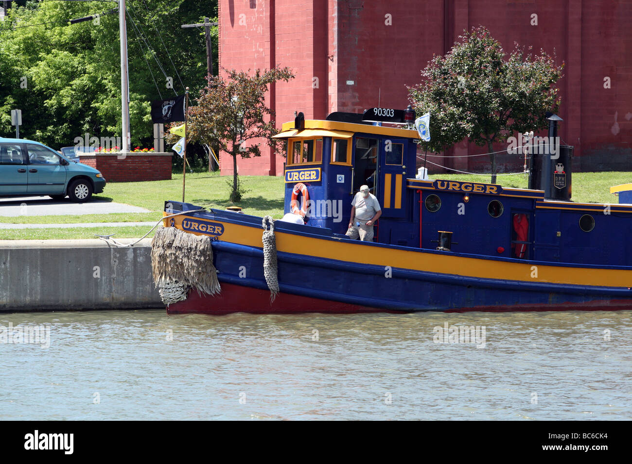 The historic and colourful colorful canal tug "Urger" being painted at ...