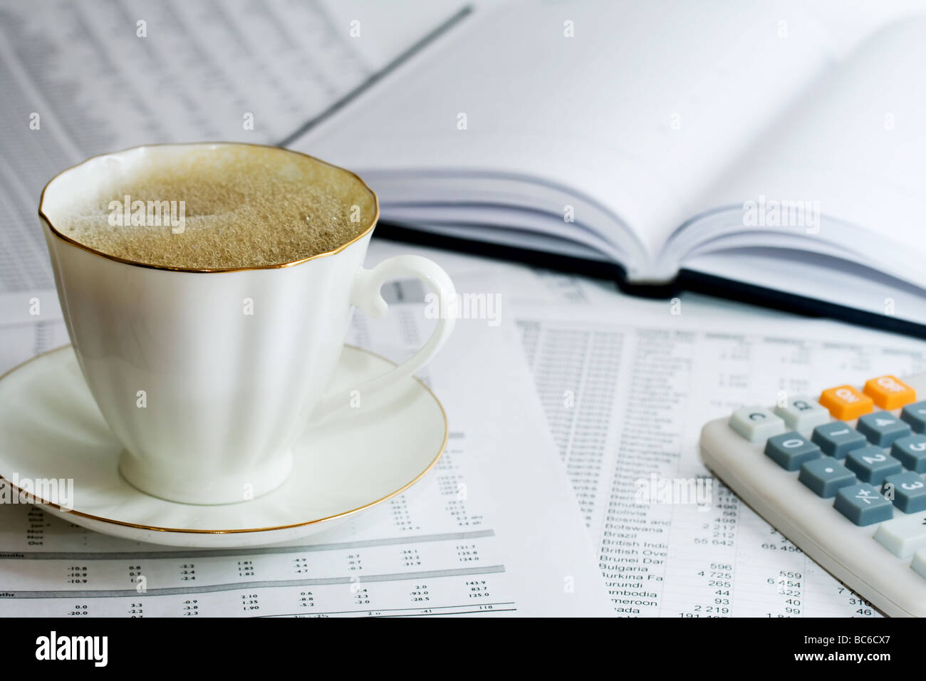 Cup of coffee and financial accounting Stock Photo - Alamy