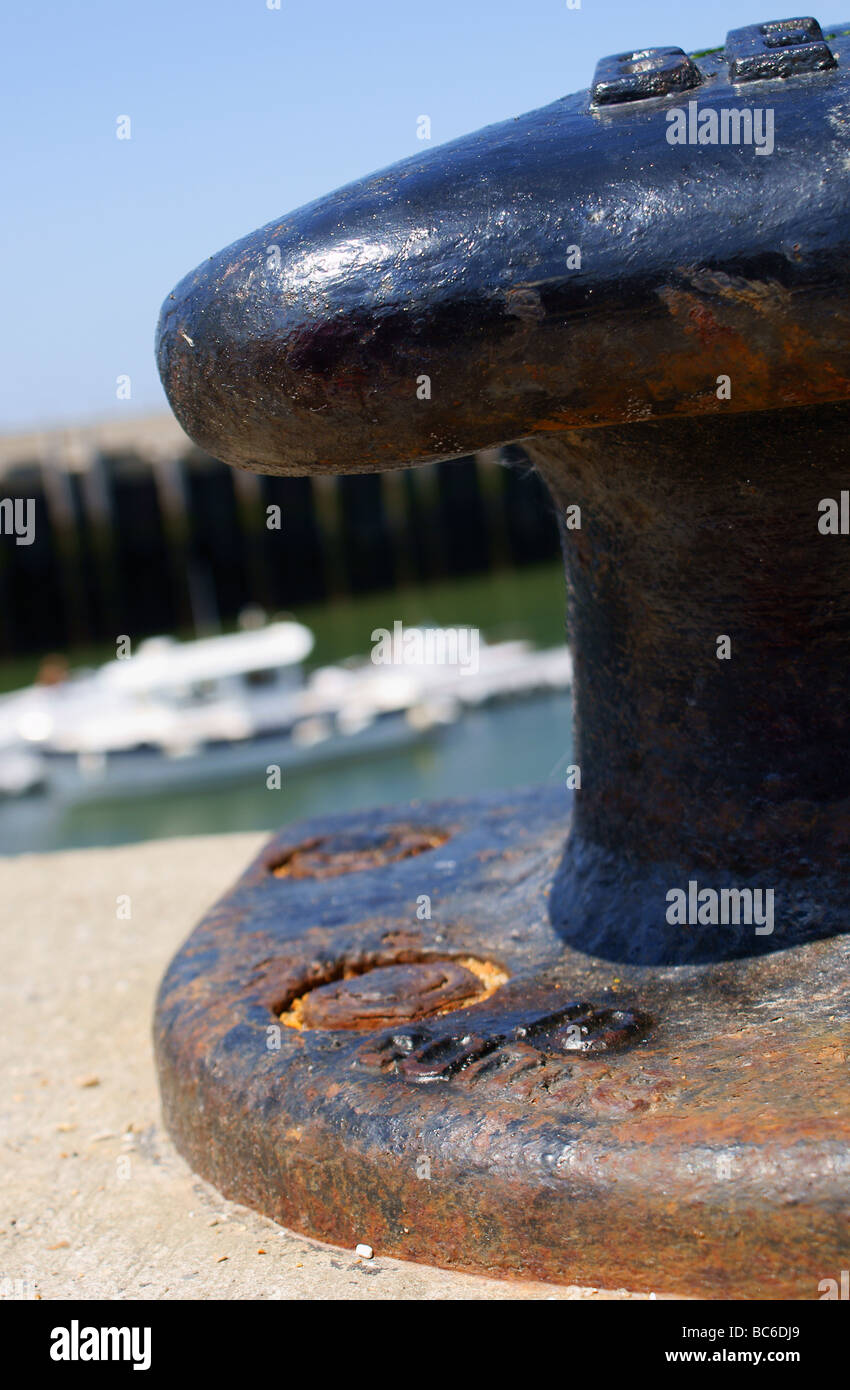 Boat mooring post at a sea harbour. Close-up with blue sky background ...