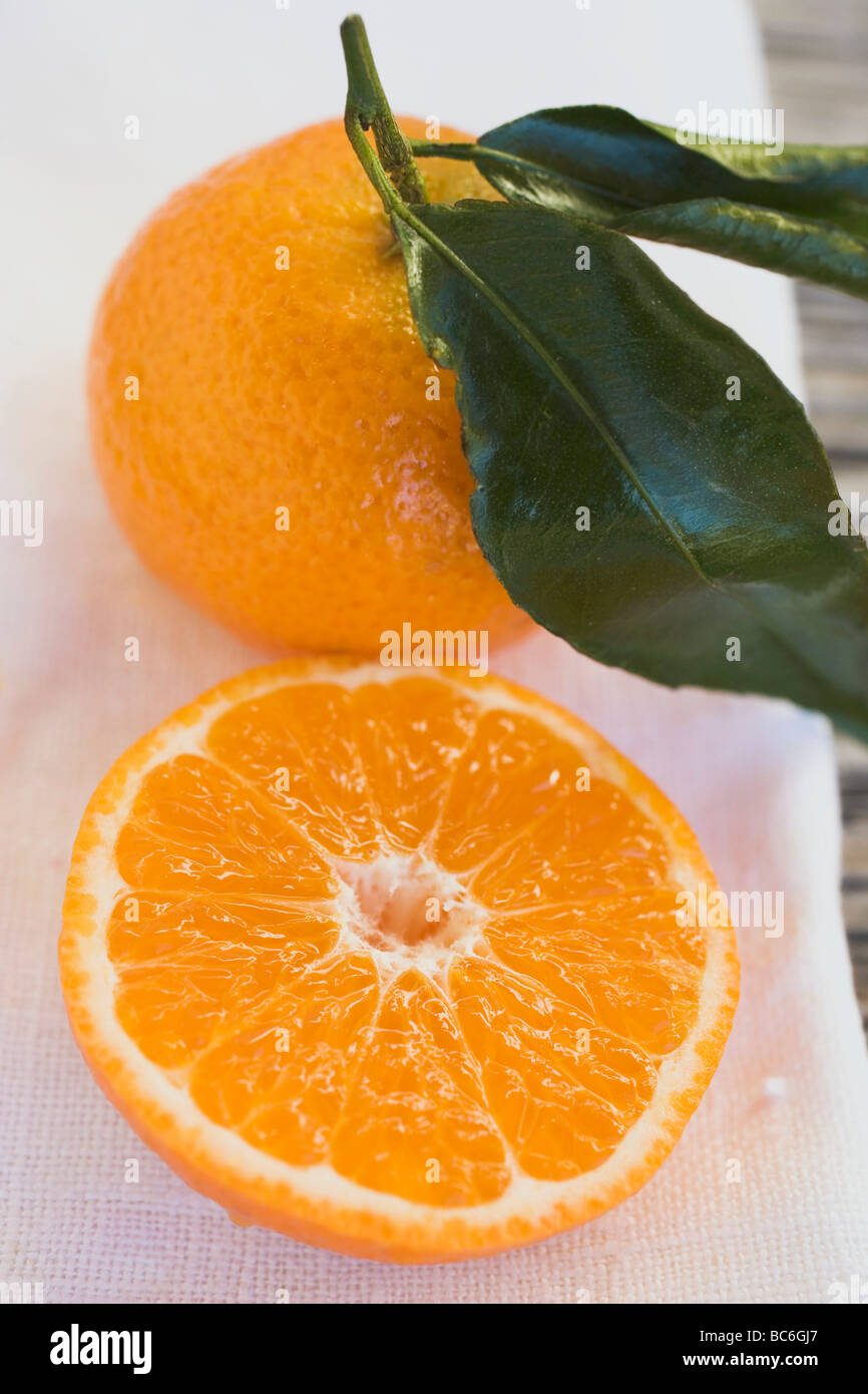 Whole clementine and a half clementine Stock Photo - Alamy