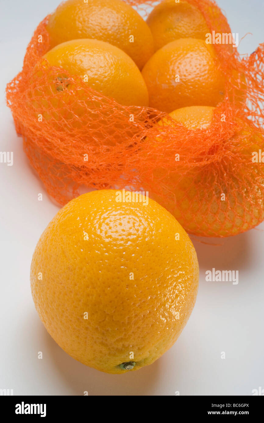 Oranges in a net Stock Photo - Alamy