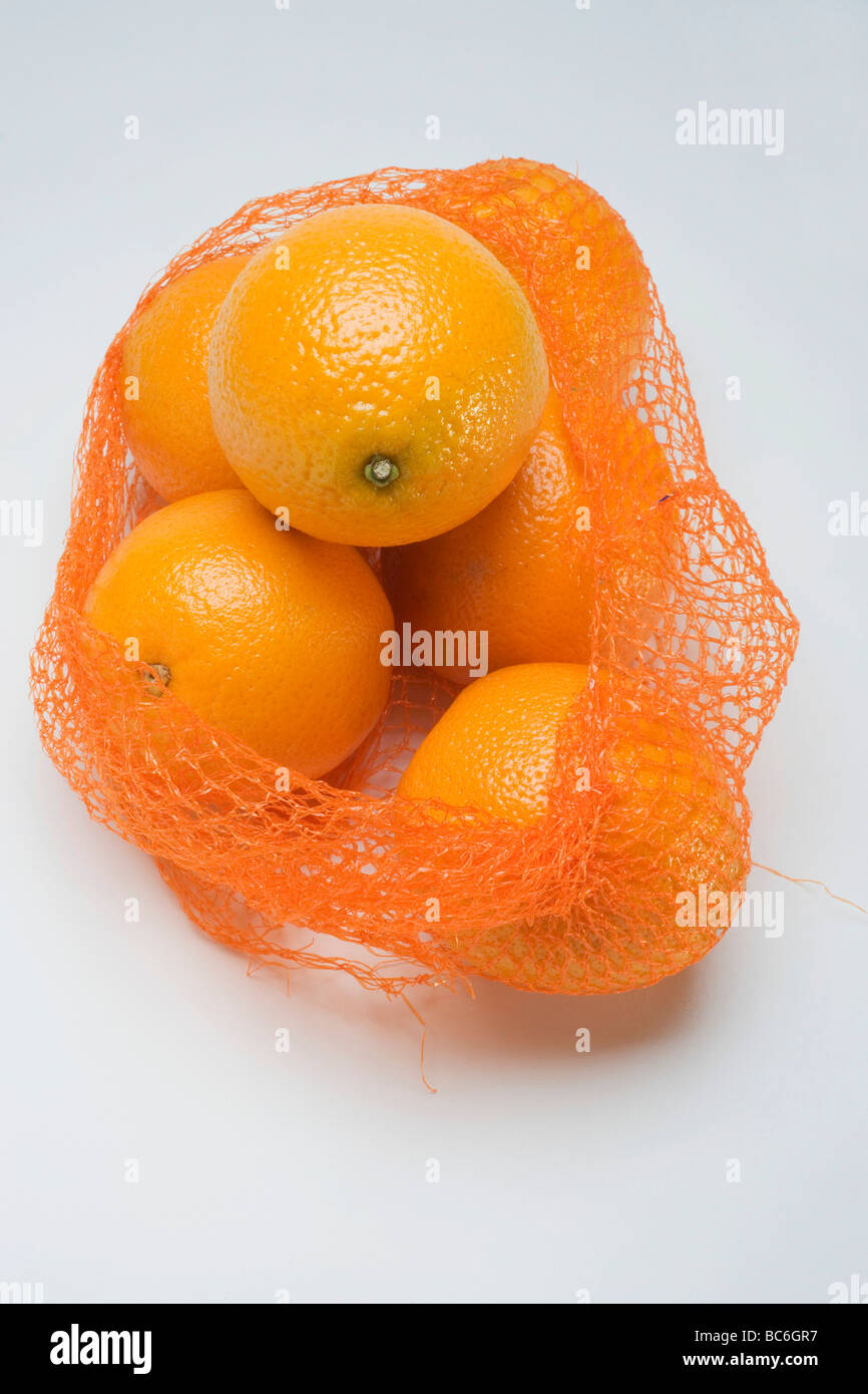 Oranges in a net Stock Photo - Alamy