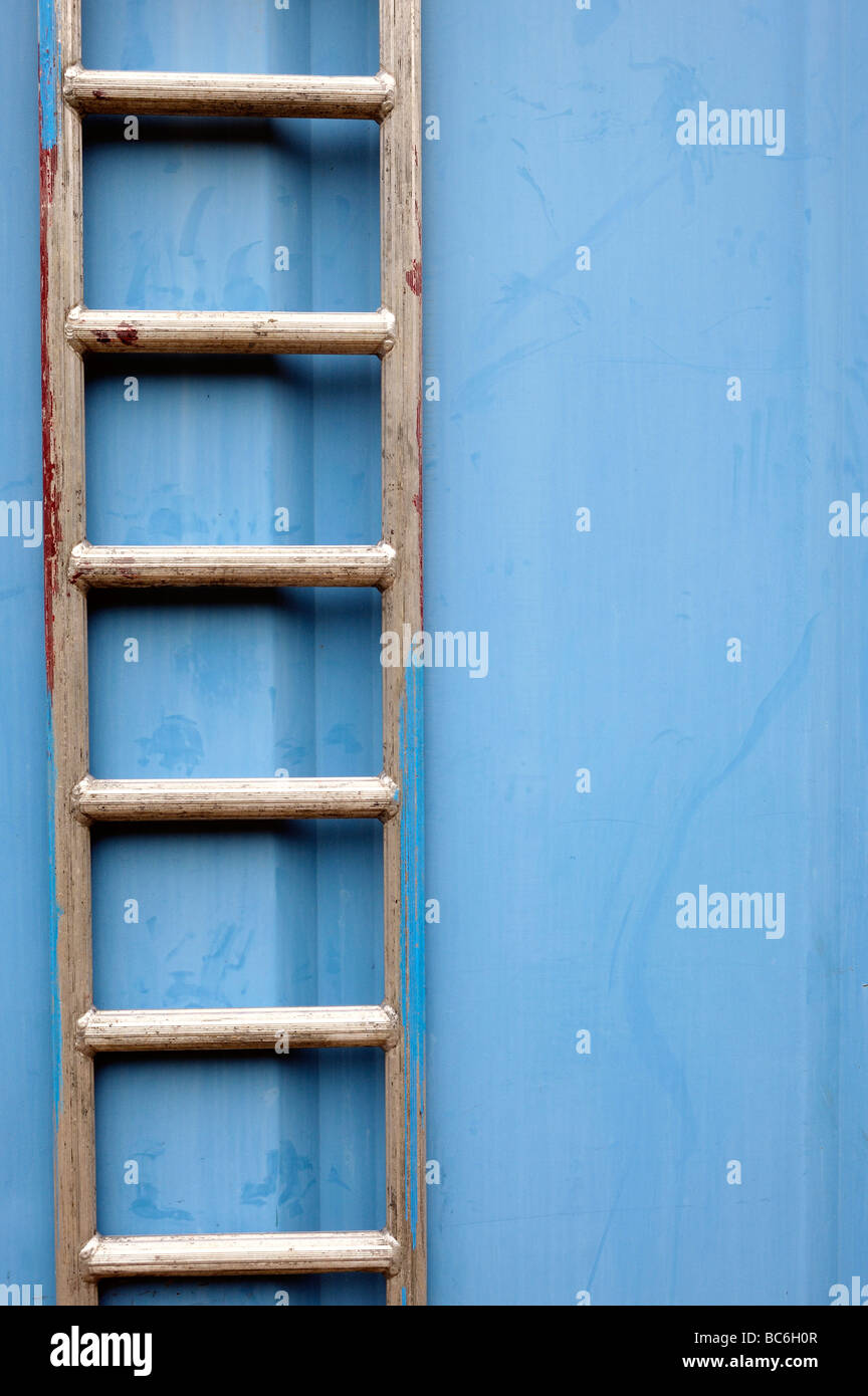 Ladder against a blue structure Stock Photo - Alamy