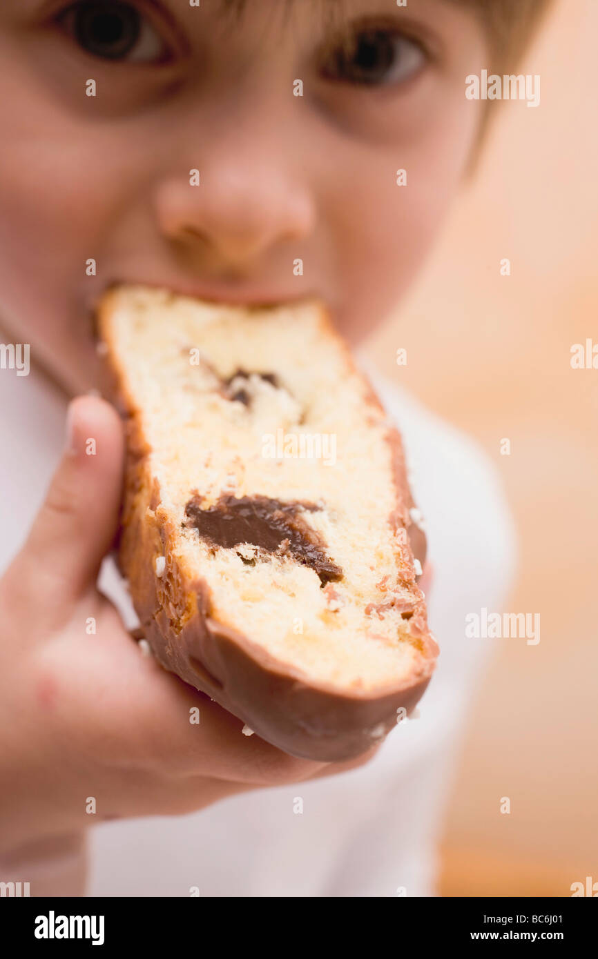 Child biting into a piece of Easter cake Stock Photo - Alamy