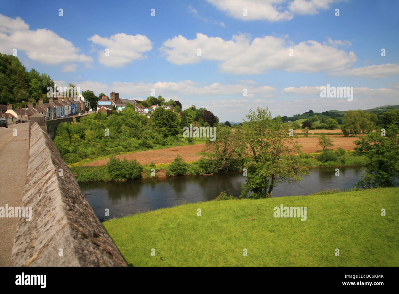 Stone bridge crossing the River Towy below the hillside town of ...