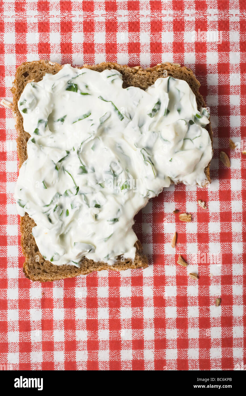 Quark & ramsons on wholemeal bread, a bite taken (overhead Stock Photo ...