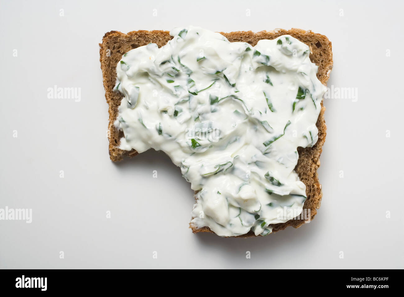 Quark & ramsons on wholemeal bread, a bite taken (overhead Stock Photo ...