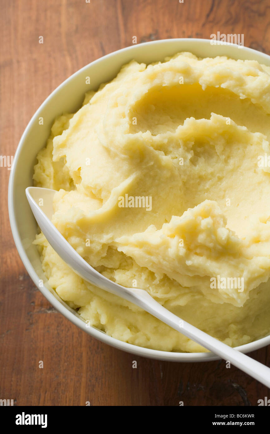 Mashed potato in white bowl with spoon Stock Photo - Alamy