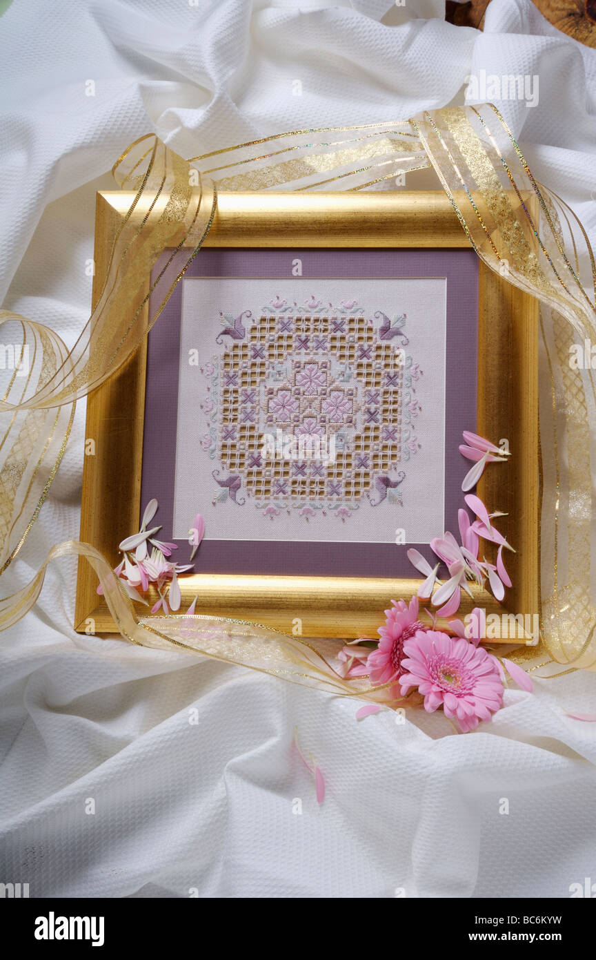 Still-life of piece of embroidery in gilt frame Stock Photo - Alamy
